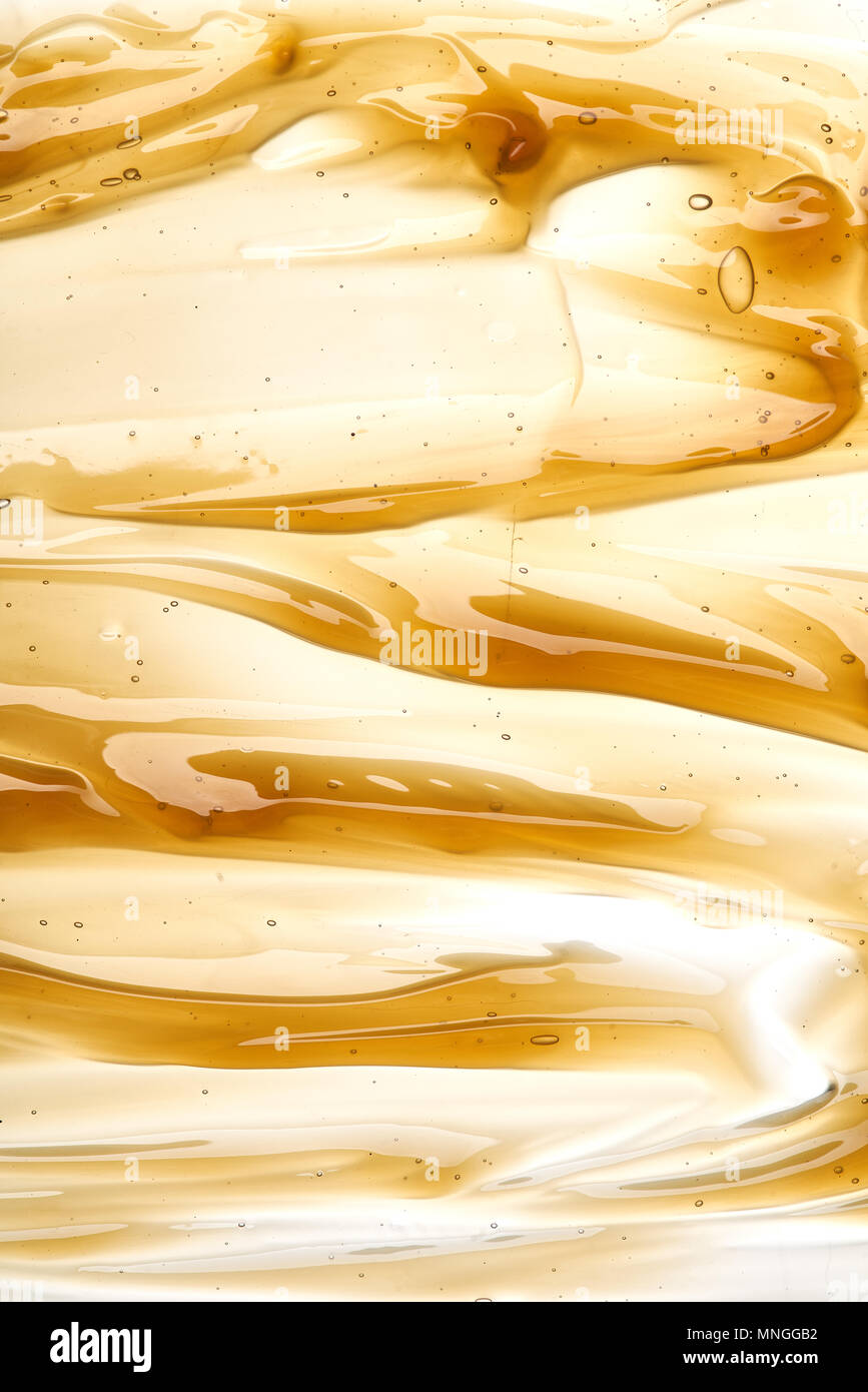 Transparent yellow smear of face cream or golden honey isolated on ...