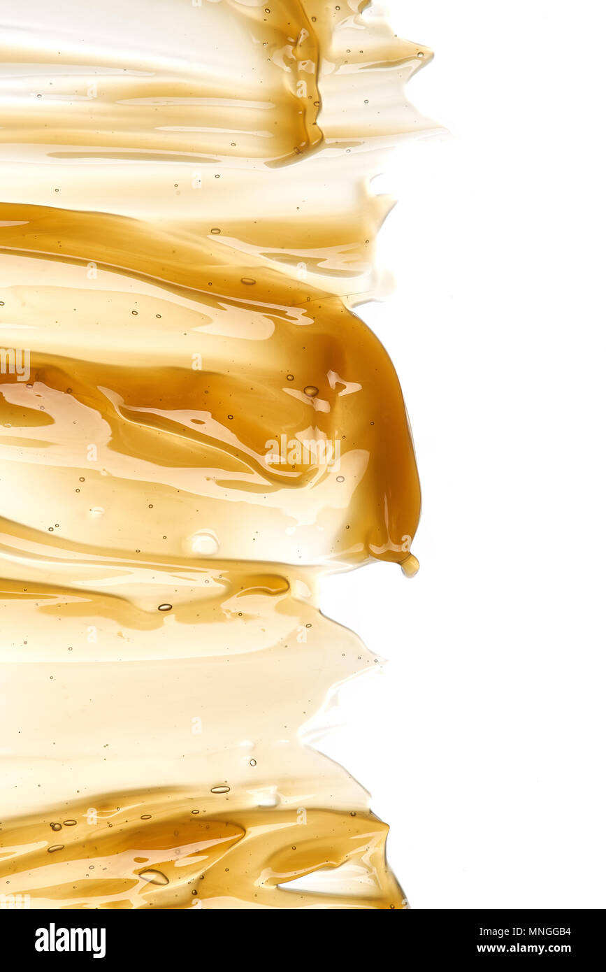 Transparent yellow smear of face cream or golden honey isolated on ...