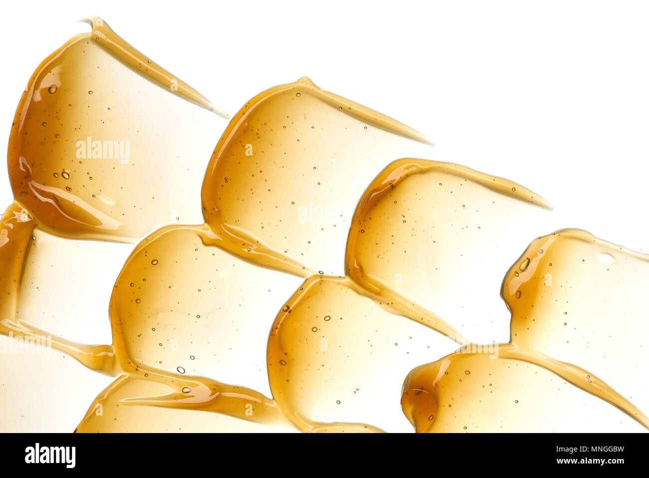 Transparent yellow smear of face cream or golden honey isolated on ...