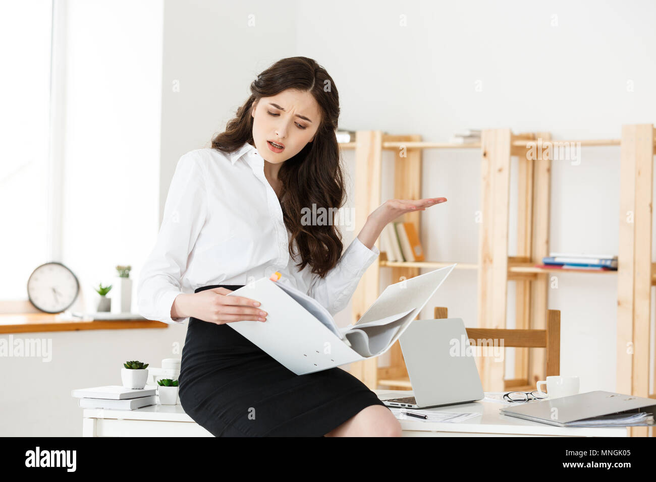 Worried businesswoman reading a notification report while is working ...