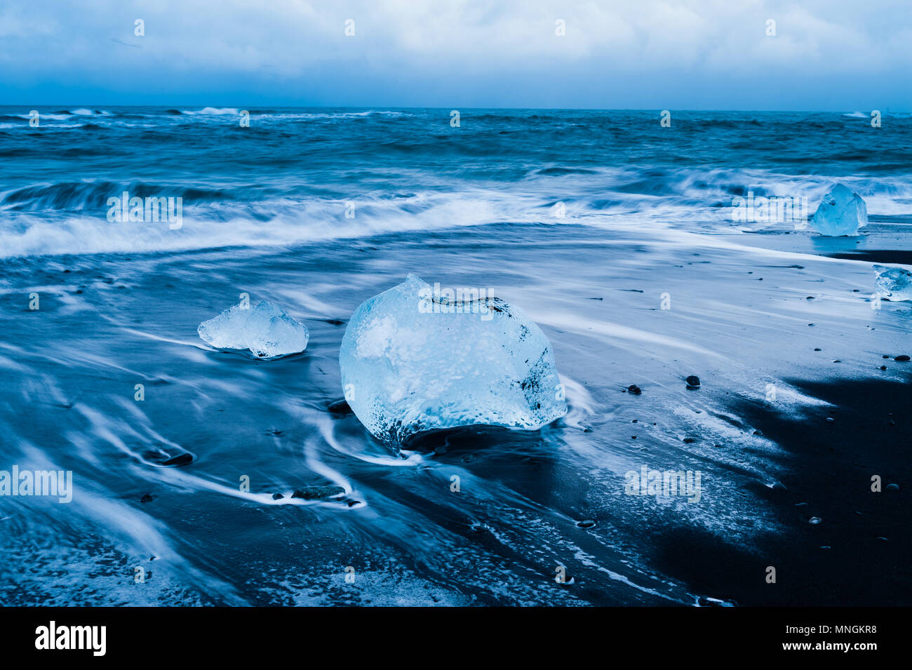 Ice rocks washed by the upcoming surf of the atlantic ocean at black ...