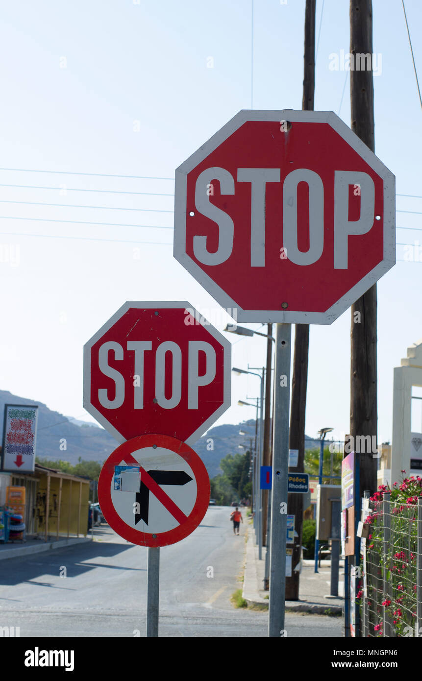 Two road sign with the inscription "Stop" and the arrow sign "Turn is ...