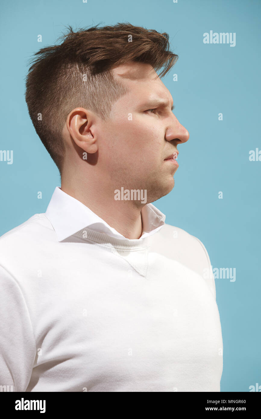 Beautiful bored man isolated on studio background Stock Photo - Alamy