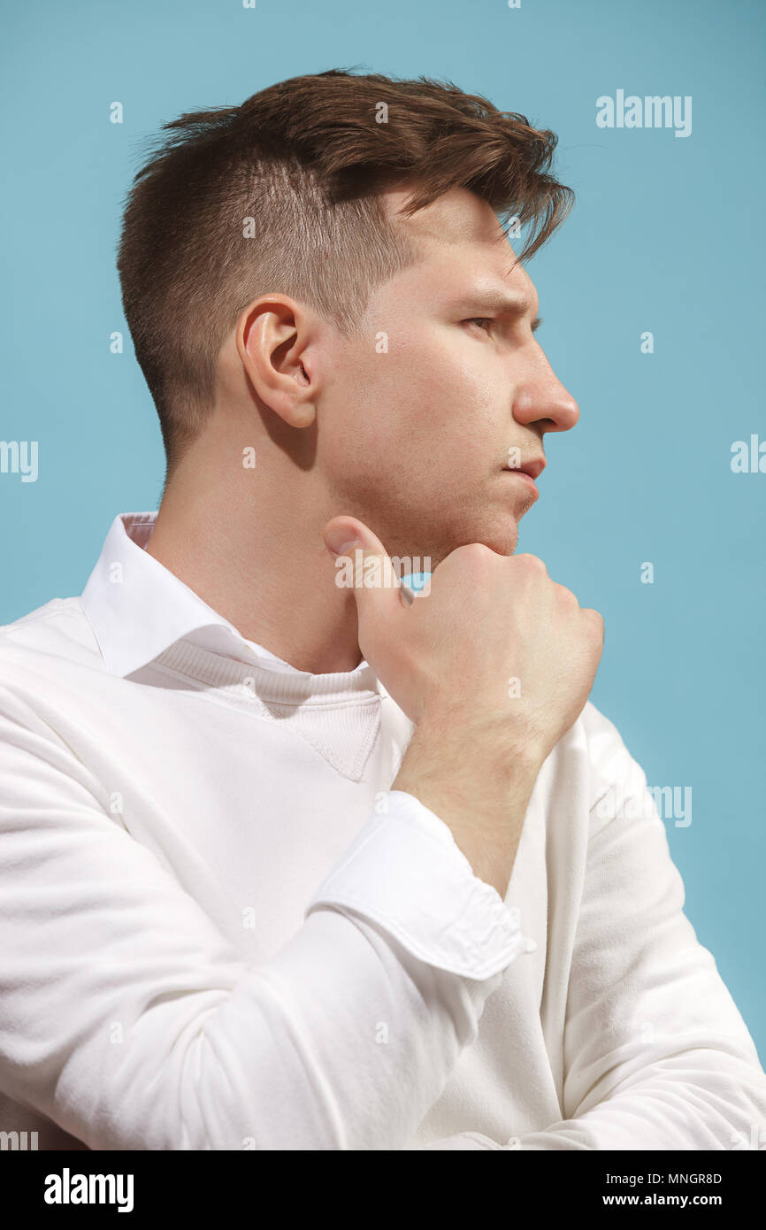 Beautiful bored man isolated on studio background Stock Photo - Alamy