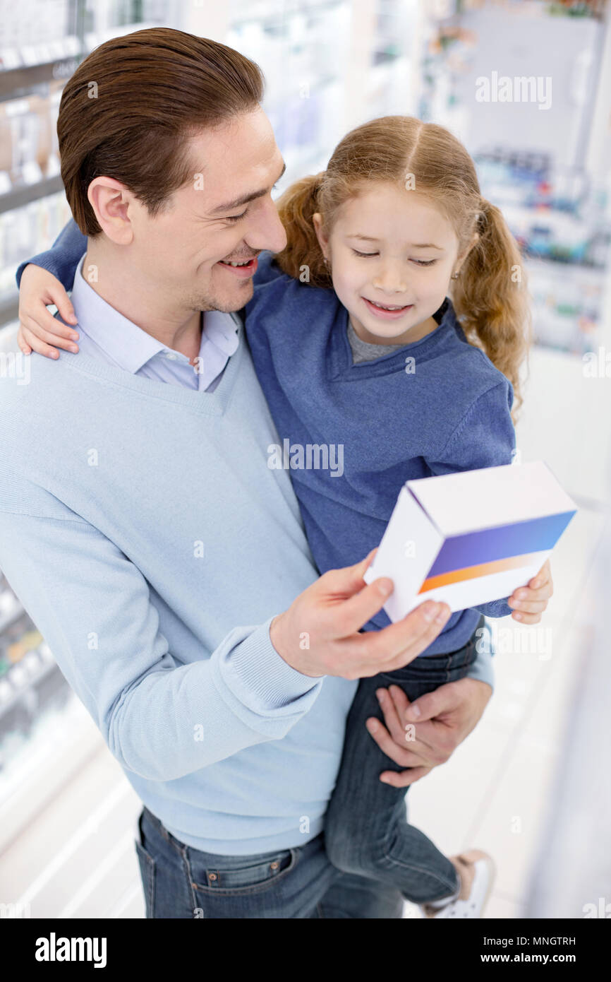 Cheerful attractive man and girl grabbing medication Stock Photo - Alamy