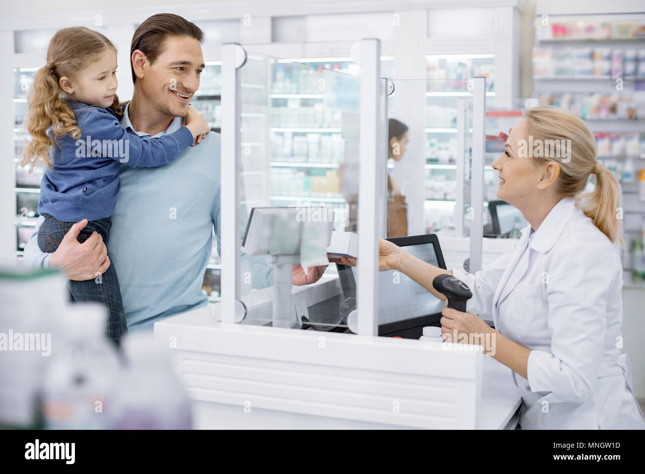 Professional pharmacist helping female customer hi-res stock ...