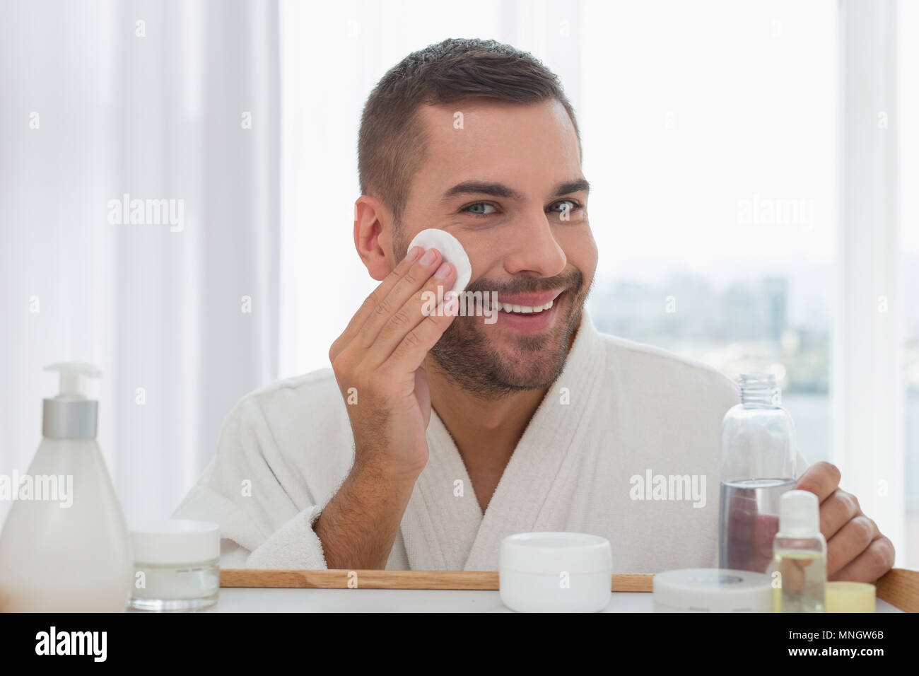 Cheerful nice man smiling to you Stock Photo - Alamy