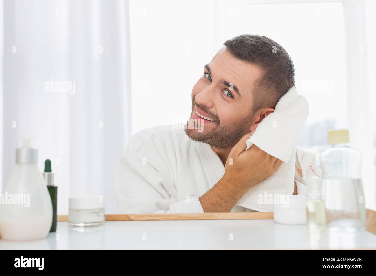 Delighted nice man drying off his hair Stock Photo - Alamy