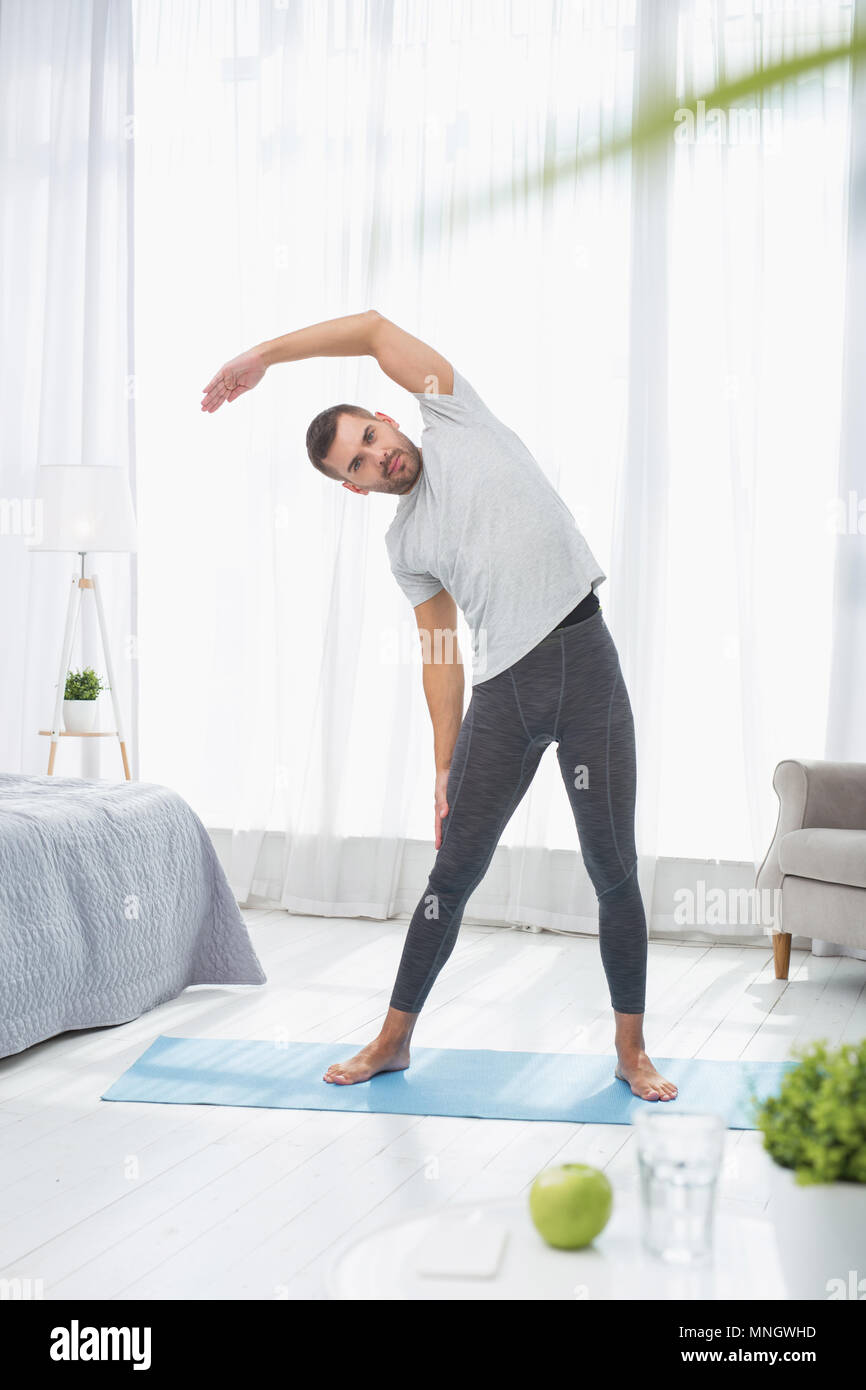 Handsome nice man doing gymnastics Stock Photo - Alamy