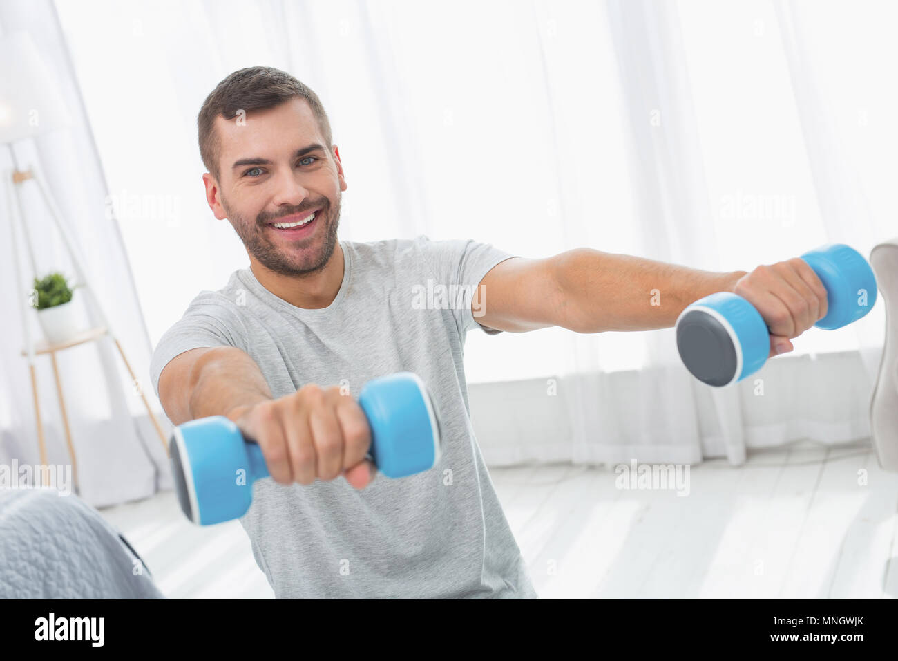 Positive delighted man stretching hi-res stock photography and images ...