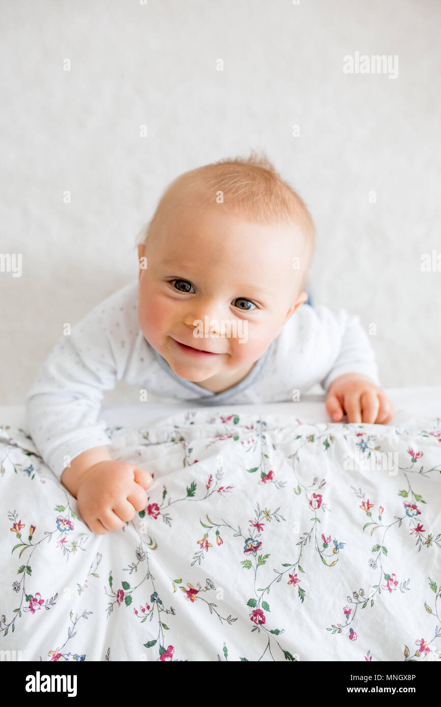 Portrait of cute little toddler child shot from above, baby boy smiling ...