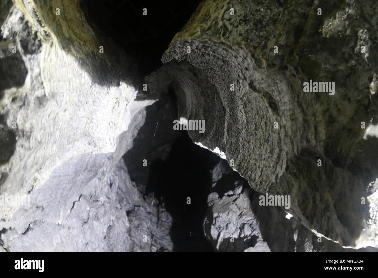 Half-filled with rock and clay natural cave. After collapse of ...