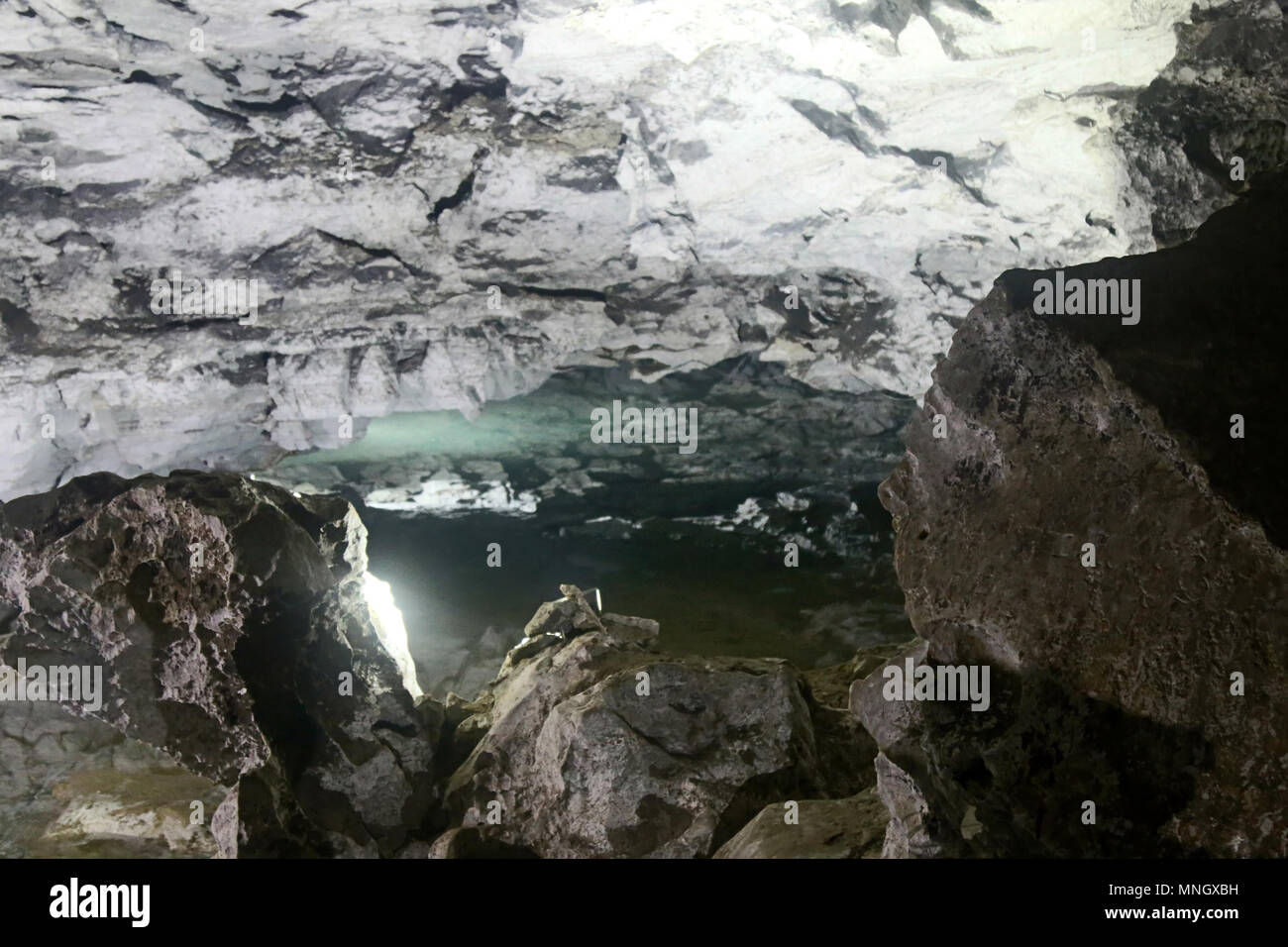 Half-filled with rock and clay natural cave. After collapse of ...