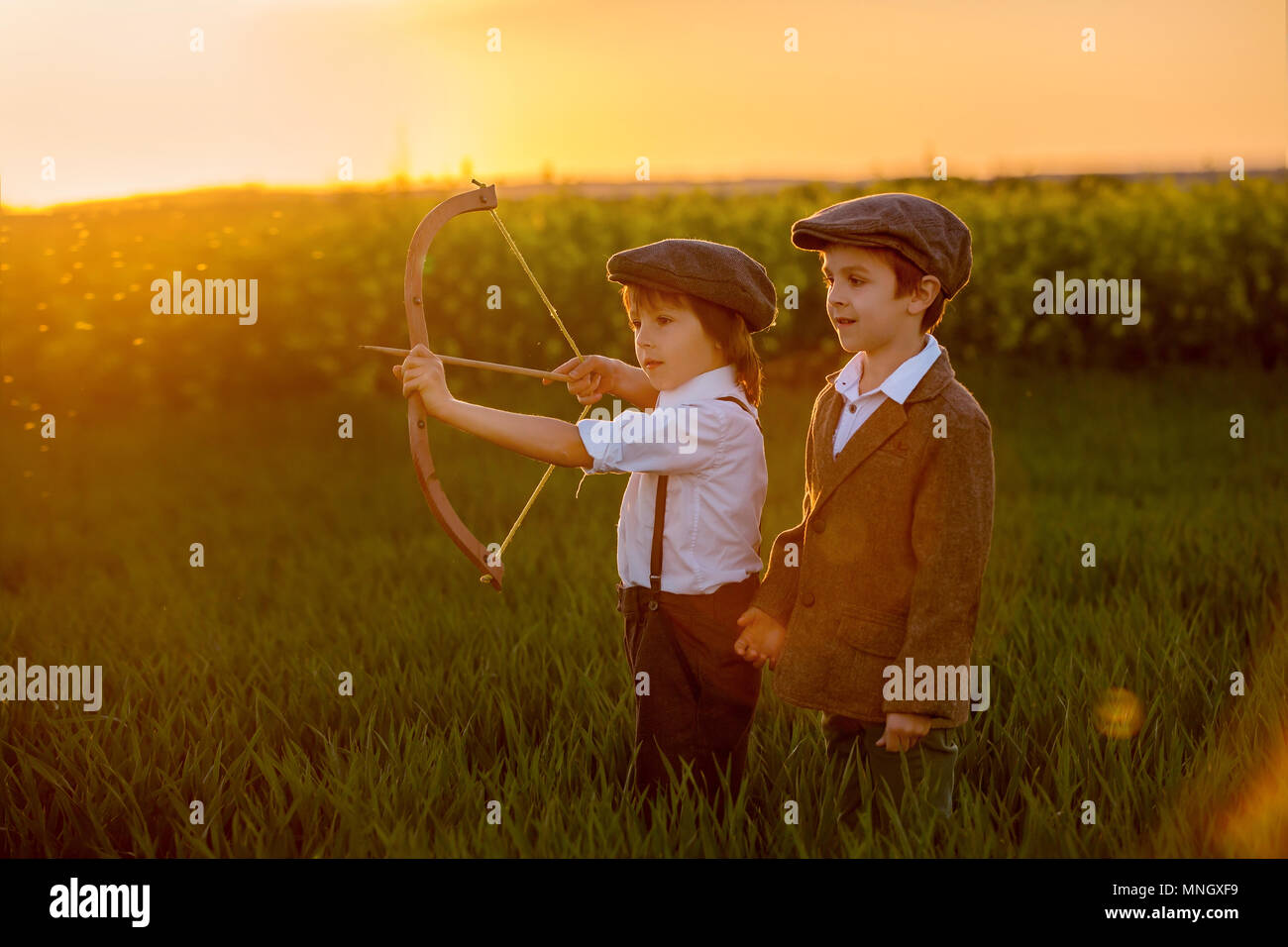 Boy playing with bow and arrow hi-res stock photography and images - Alamy