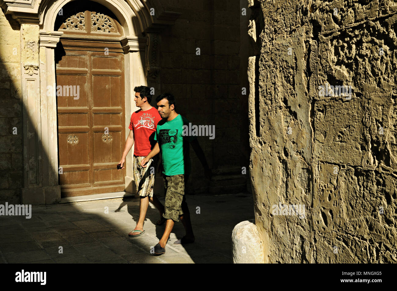 Two young men walking in the old town of Mdina, Malta Stock Photo - Alamy