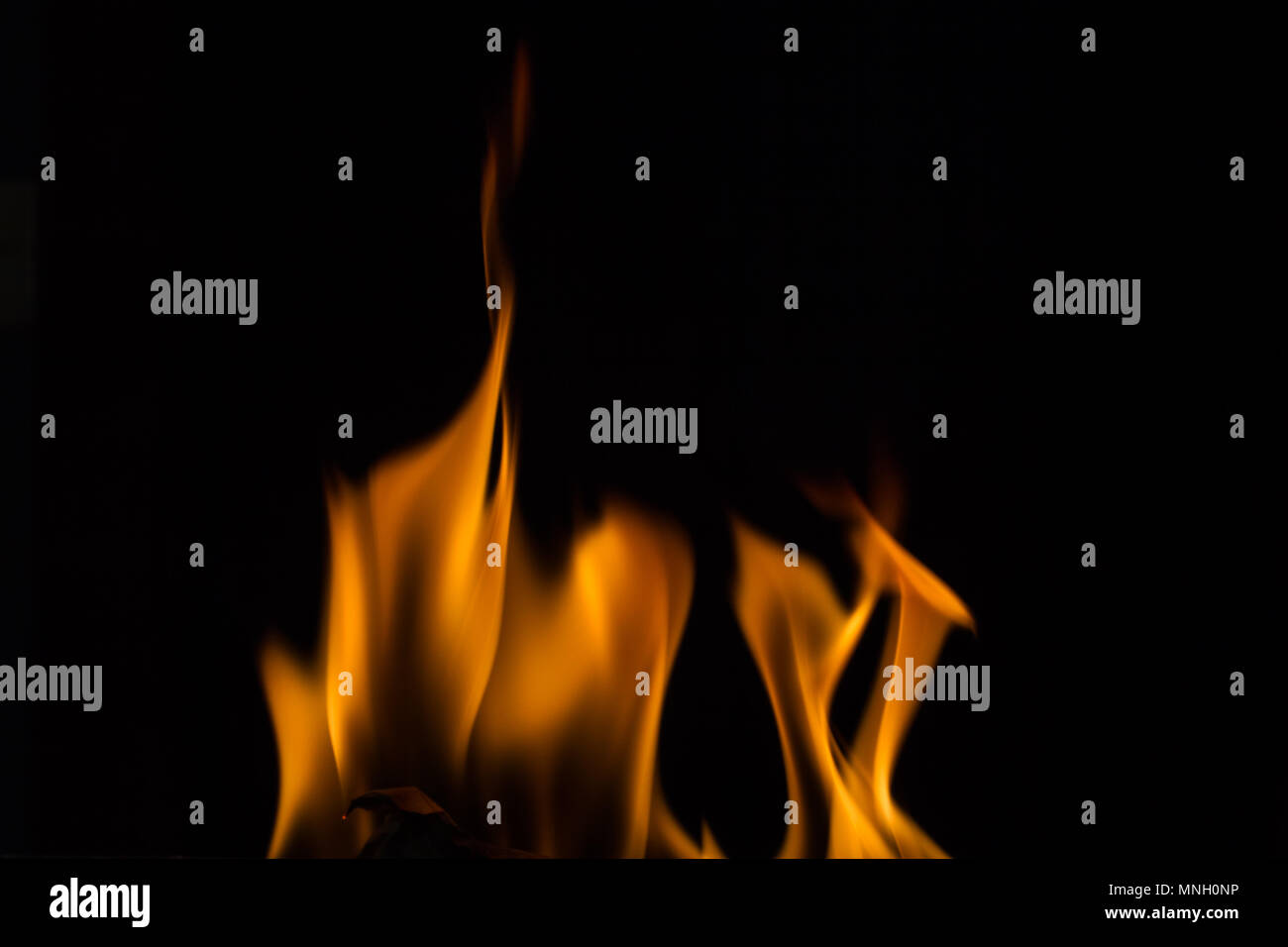 Beautiful yellow fire flames on black Stock Photo - Alamy