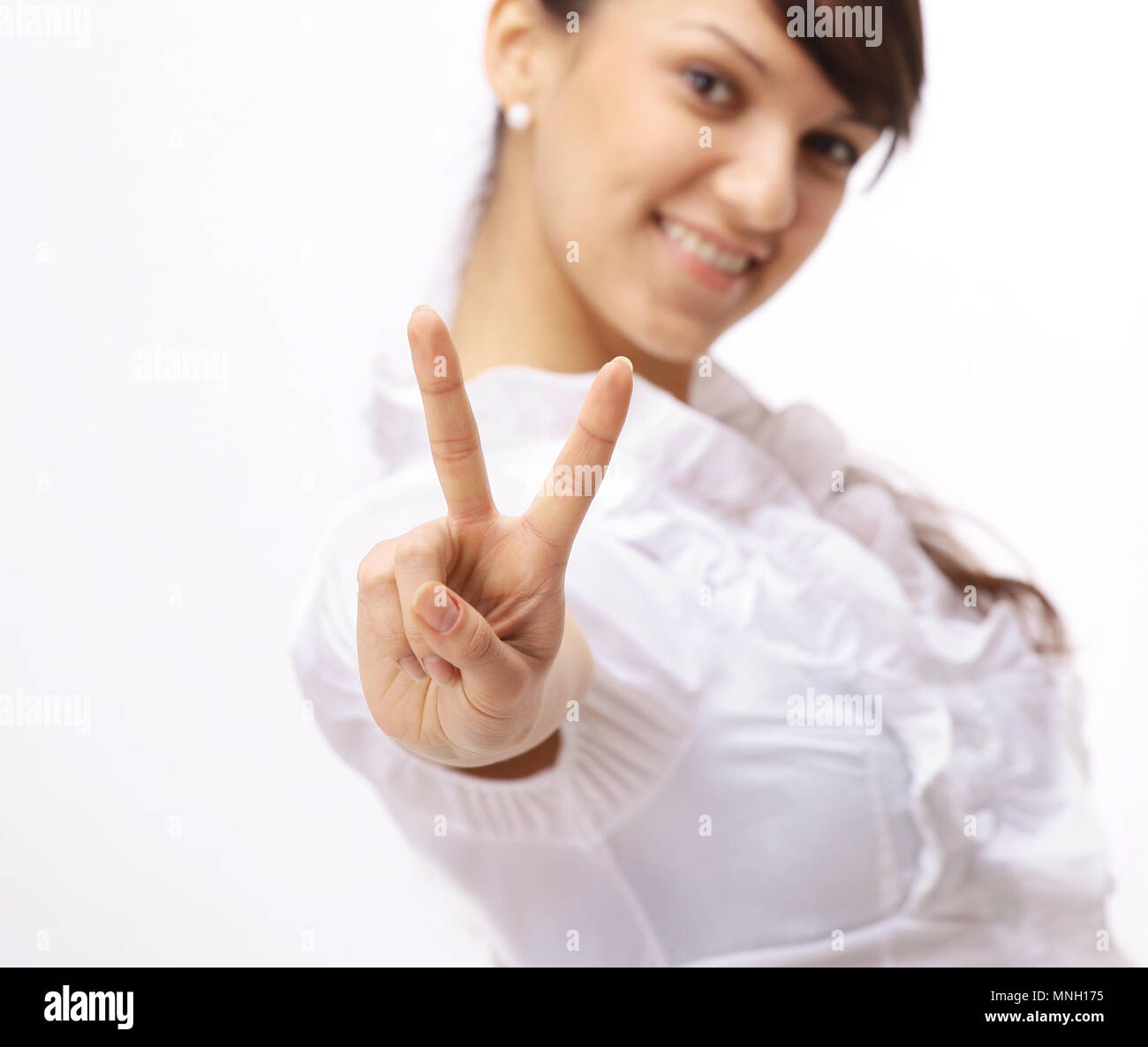 closeup.young business woman showing victory sign Stock Photo - Alamy