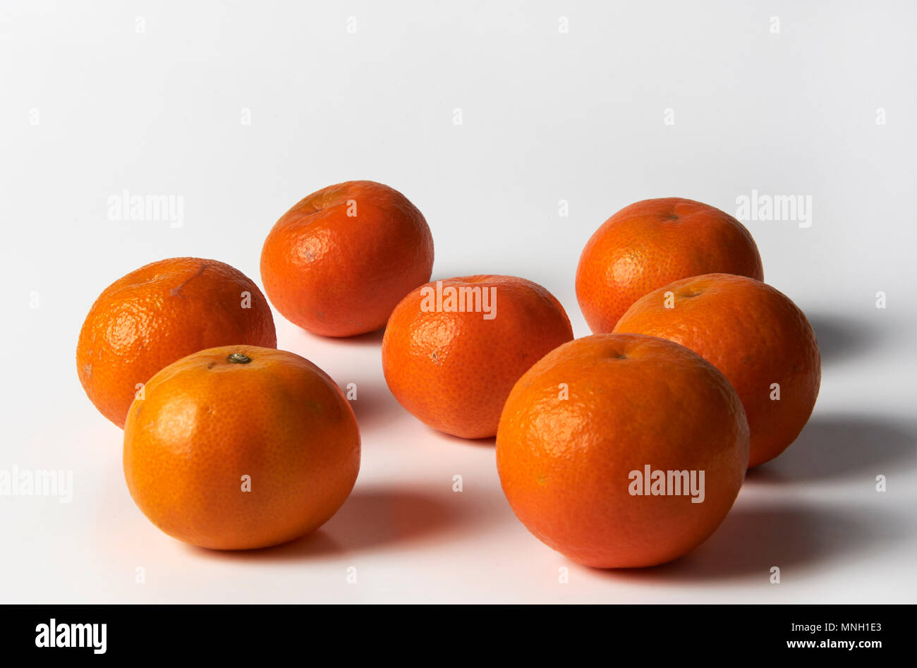 some tangerines on white background Stock Photo - Alamy