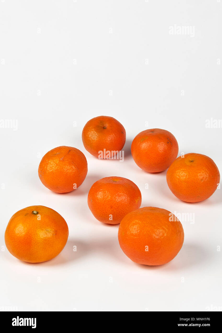 some tangerines on white background Stock Photo - Alamy