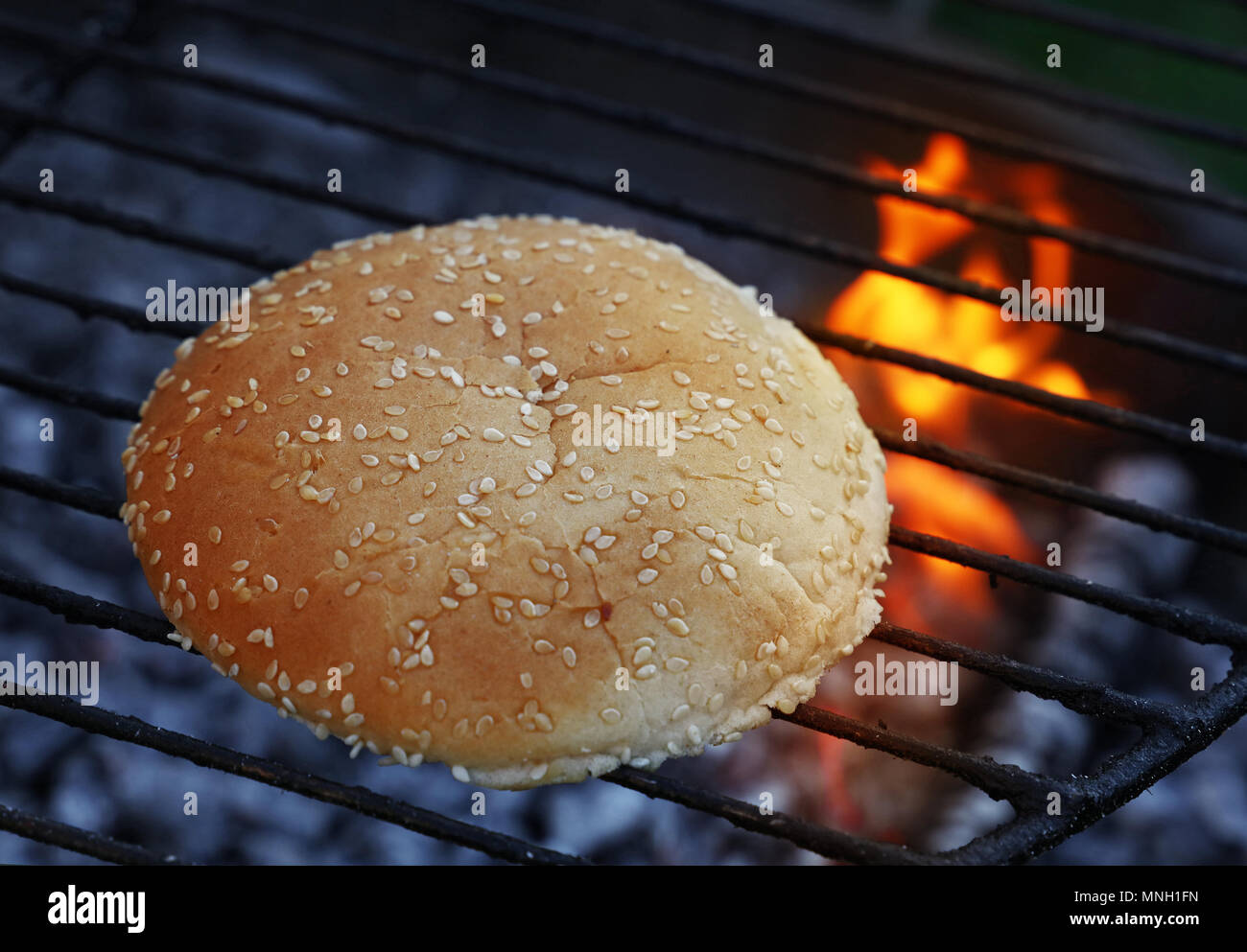 Close up sesame bun for hamburger burger cooked on fire barbecue grill ...