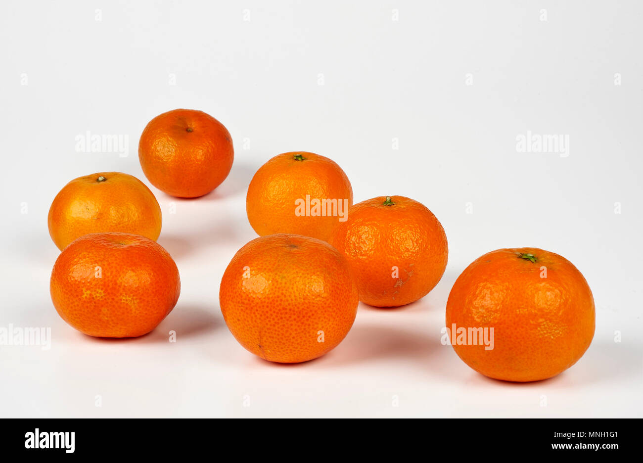 some tangerines on white background Stock Photo - Alamy