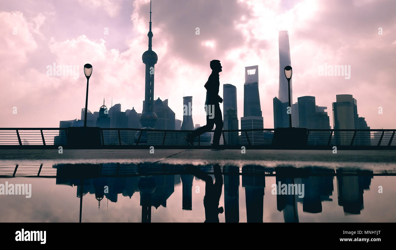 silhouette of morning run at the bund huangpu riverside, Shanghai China ...