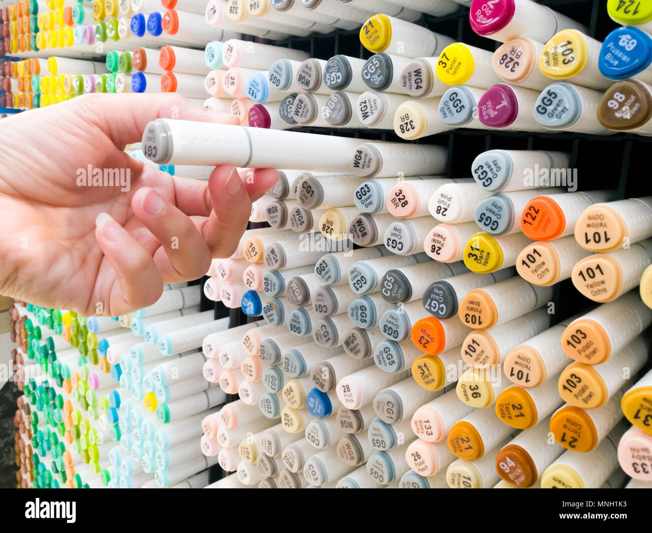 focus on women hand select the color pen on the shelf at stationery ...