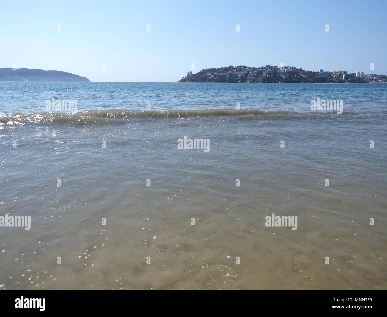 Seaside peaceful landscapes of sandy beach at bay of ACAPULCO city in ...