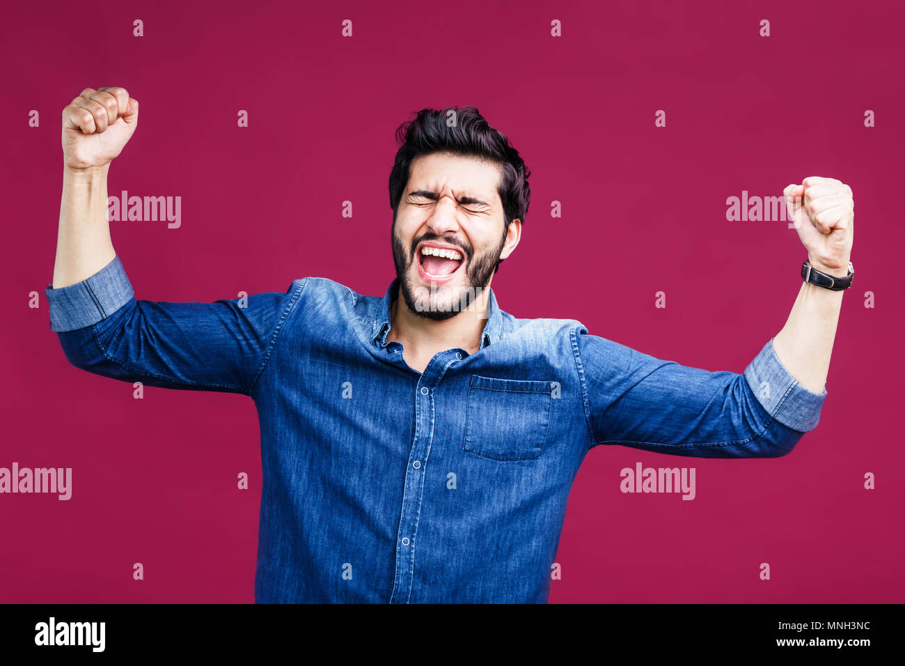 Portrait of happy successful man dressed in denim shirt on magnetta ...