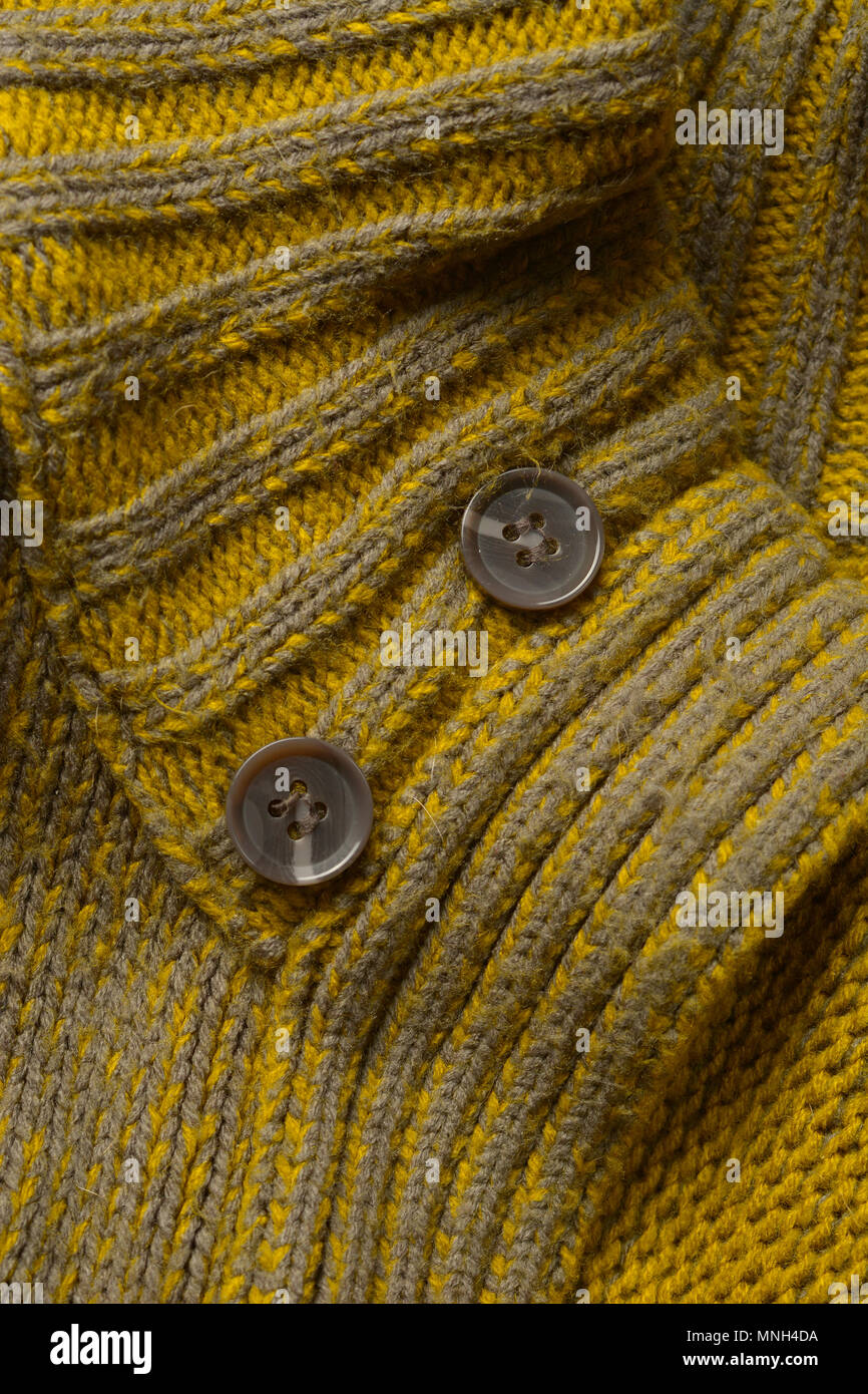 sewing buttons attached to the wool sweater - closeup Stock Photo - Alamy