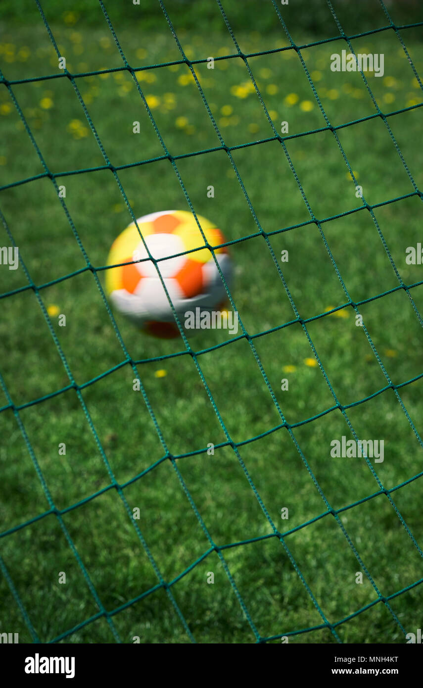 Football hitting the back of a goal net Stock Photo - Alamy