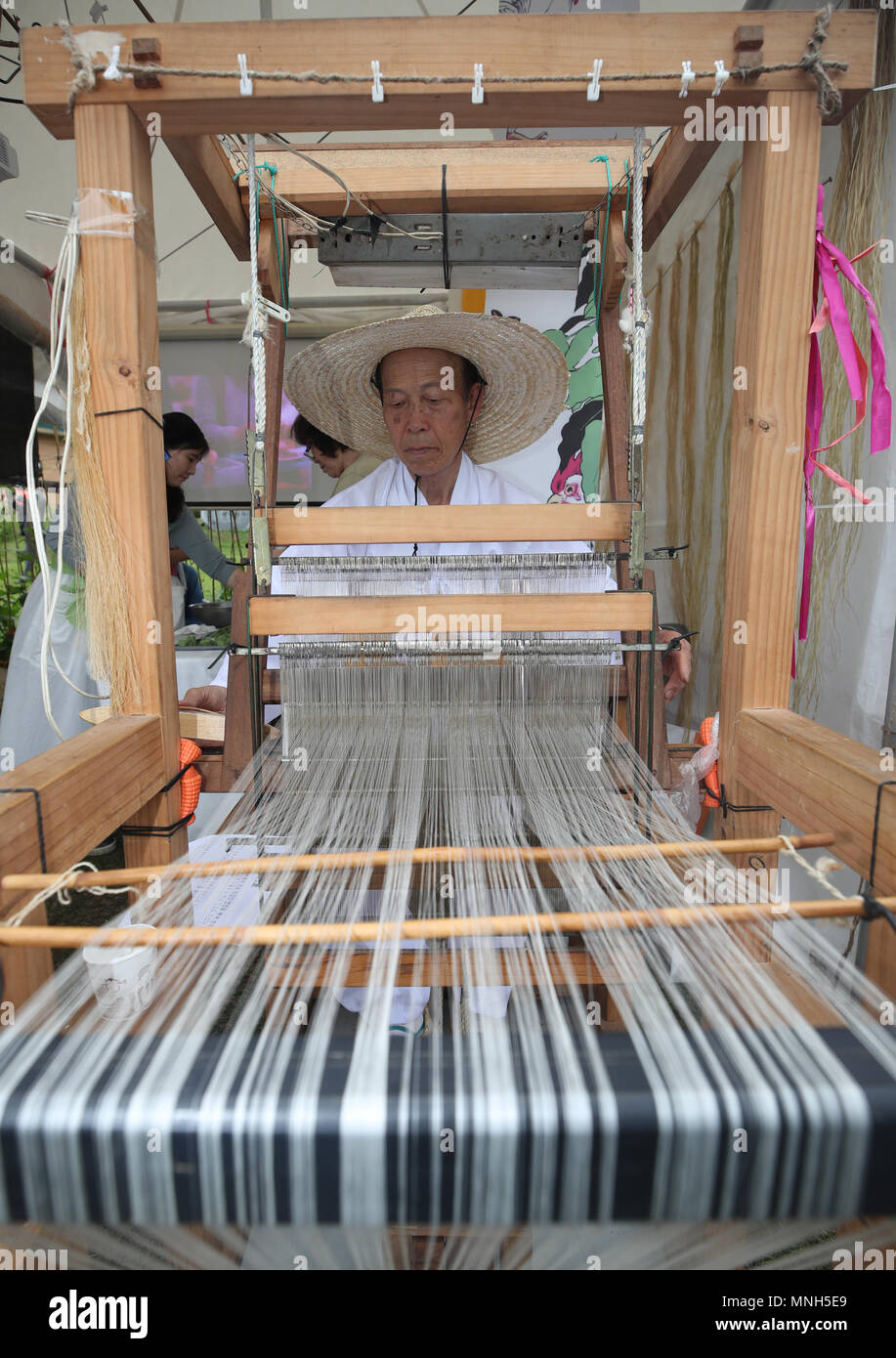 17th May, 2018. Fine ramie weaving demonstration A man demonstrates the ...