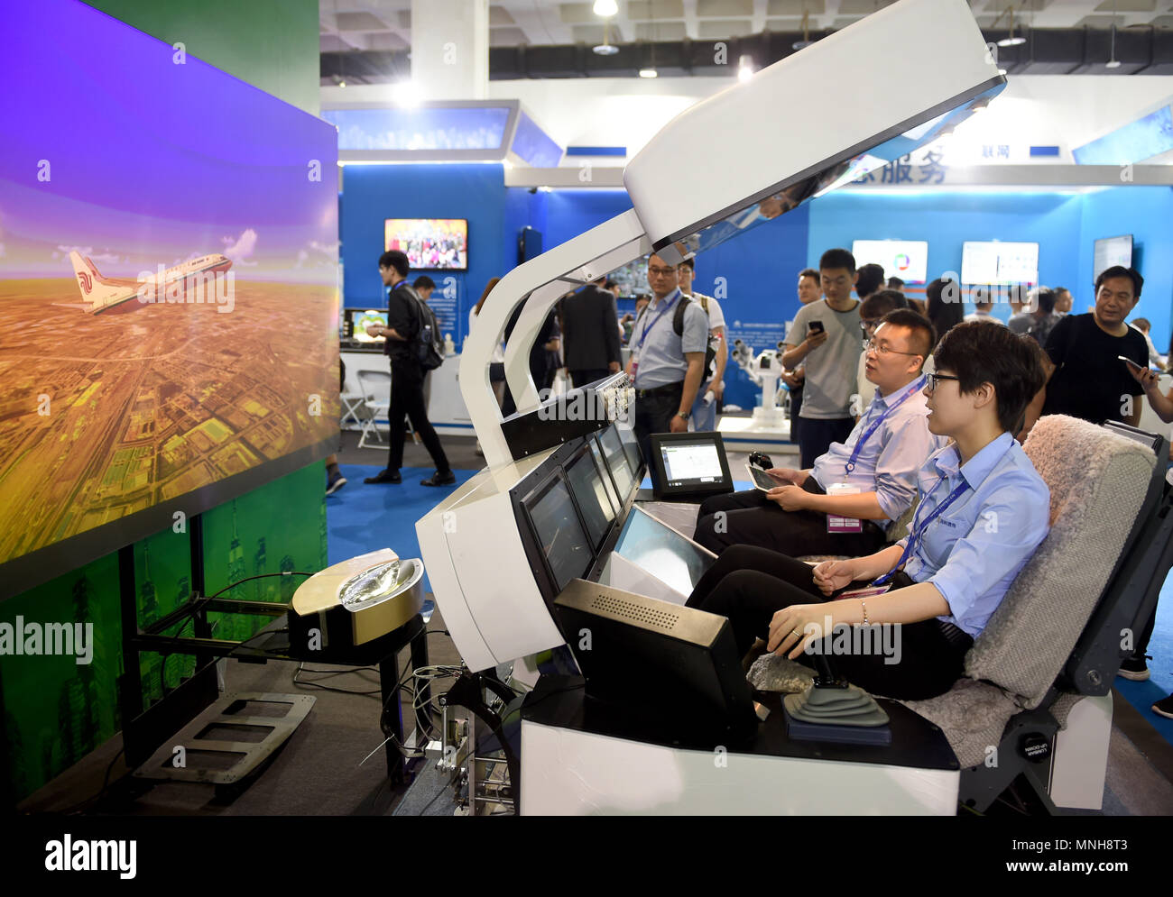 Beijing, China. 17th May, 2018. People experience a flight simulator at ...