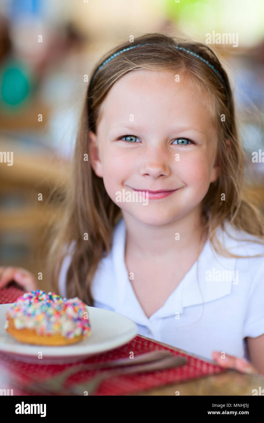 Kid eating donut hi-res stock photography and images - Alamy