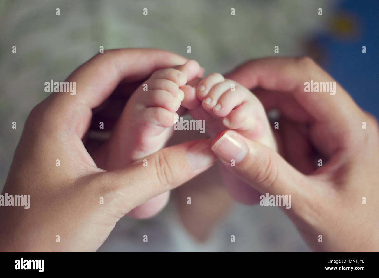 Hand holding baby feet hi-res stock photography and images - Alamy