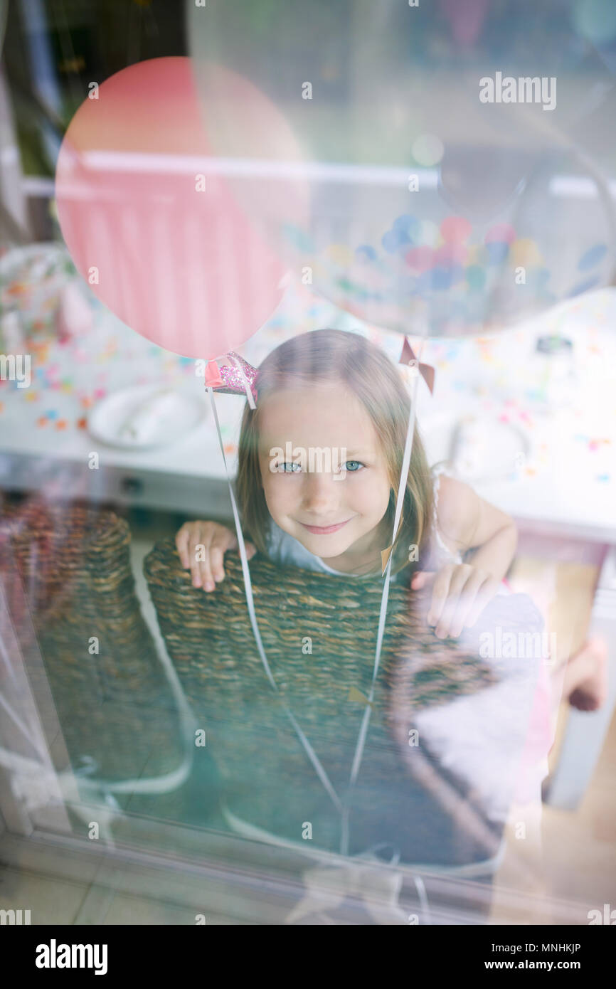 Adorable little girl with colorful balloons at kids birthday party ...
