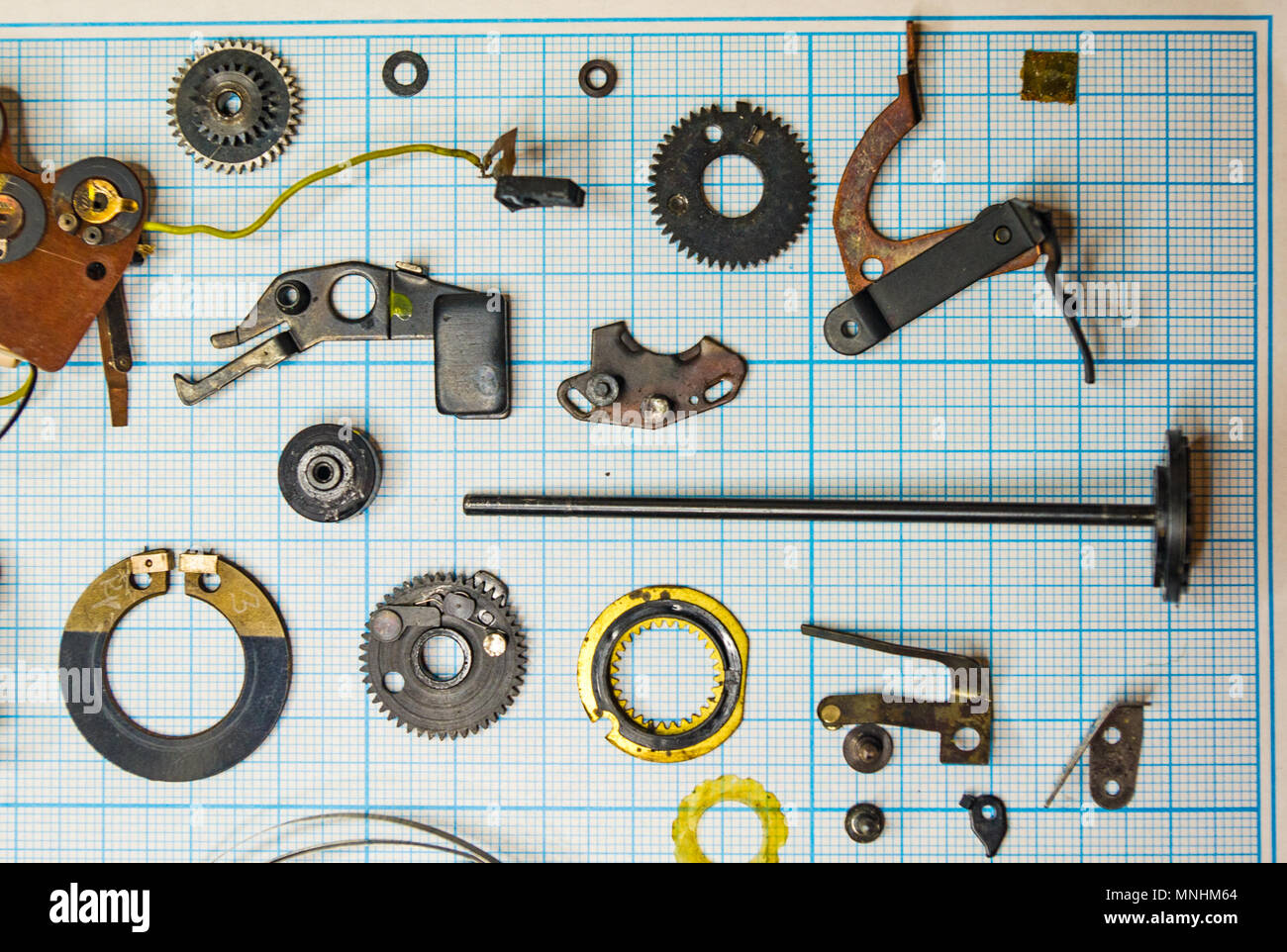 parts are completely disassembled old retro film SLR camera on graph ...