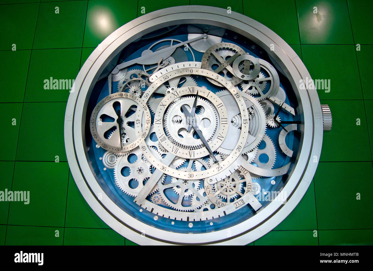 A oversized wall display of the hands, dials and internal workings of a ...