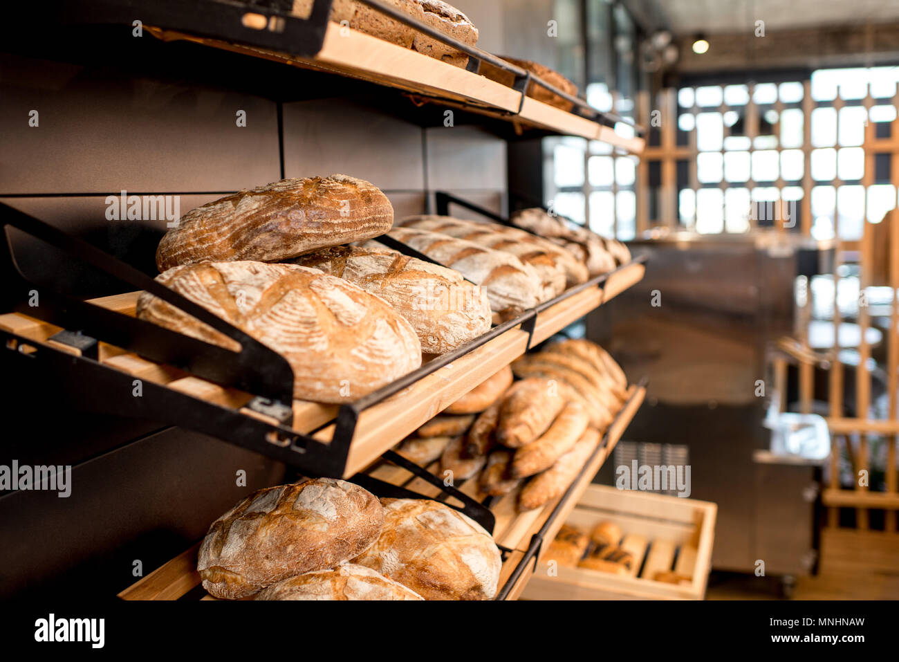 Breads on the wooden shelves of the bakery shop Stock Photo - Alamy