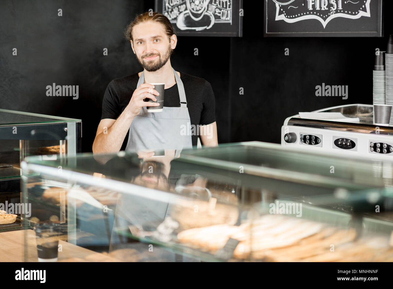 Handsome barista in uniform hi-res stock photography and images - Alamy