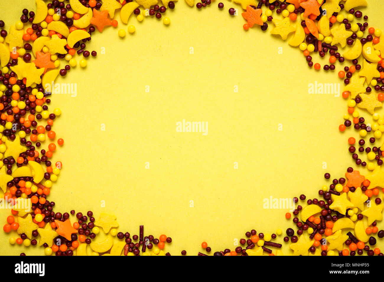 Colorful nonpareil on yellow background Stock Photo - Alamy