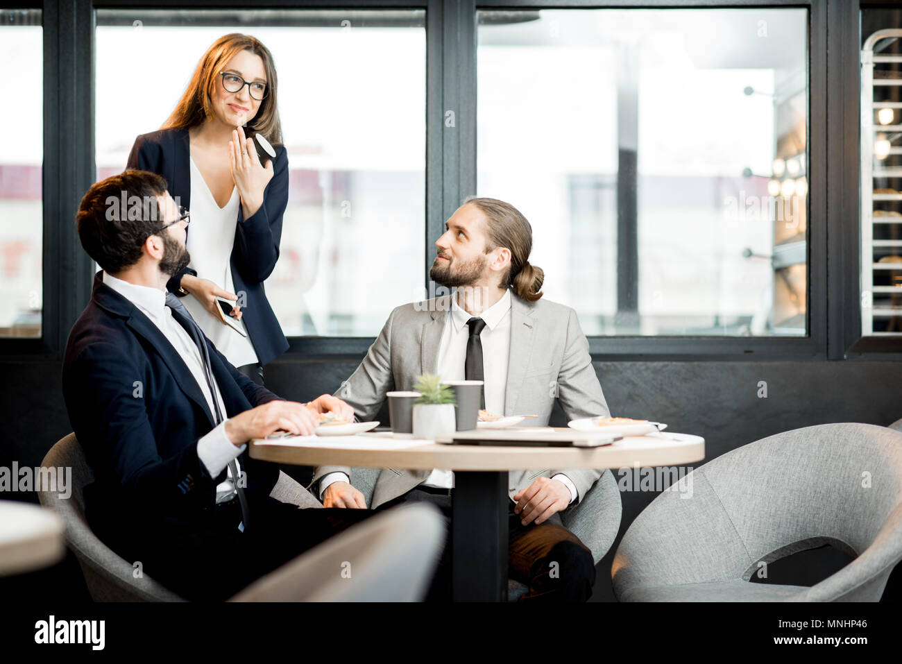 Business people having fun sitting together during the coffee break in ...