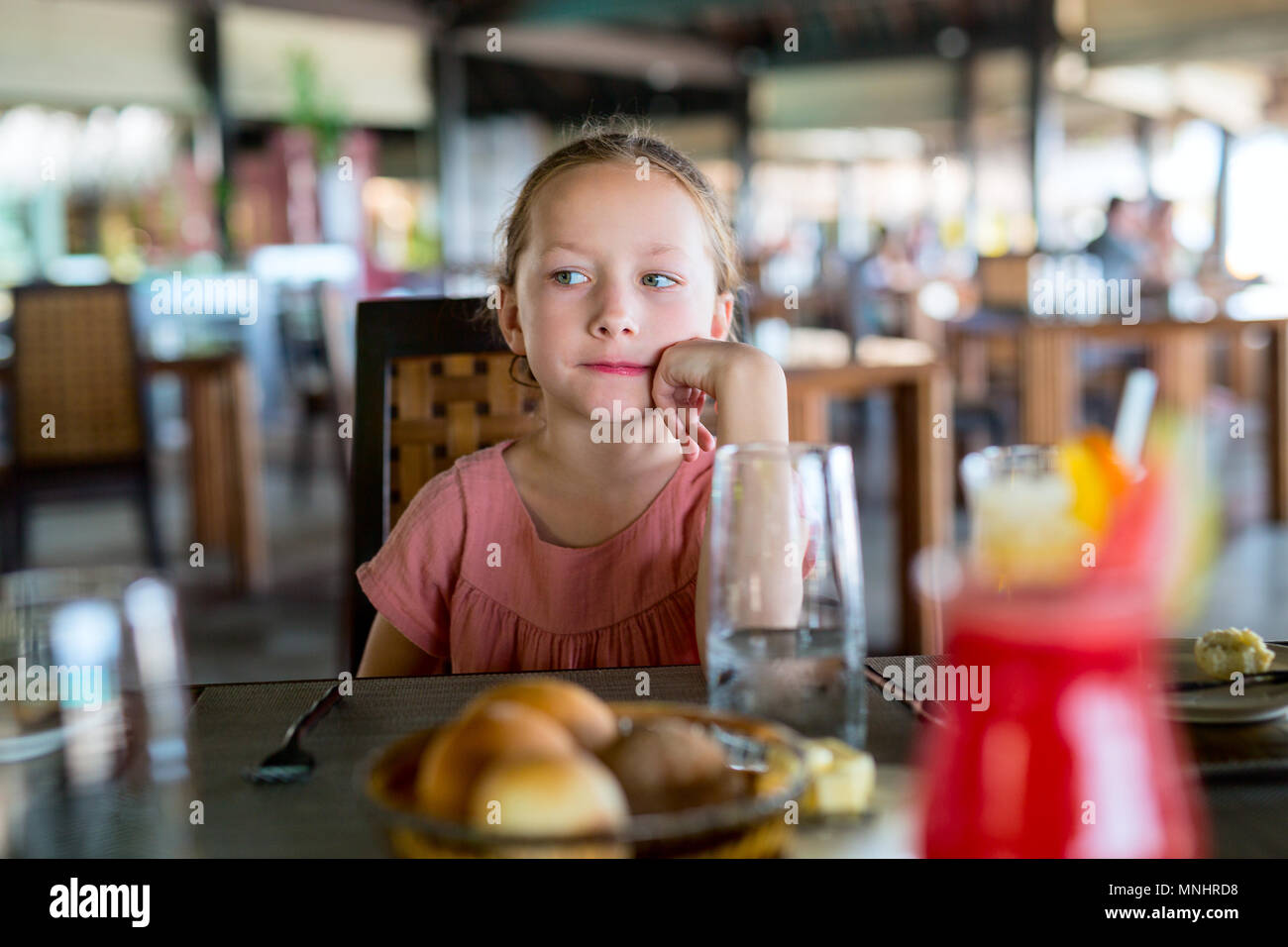 Adorable little girl eating delicious lunch in restaurant Stock Photo ...