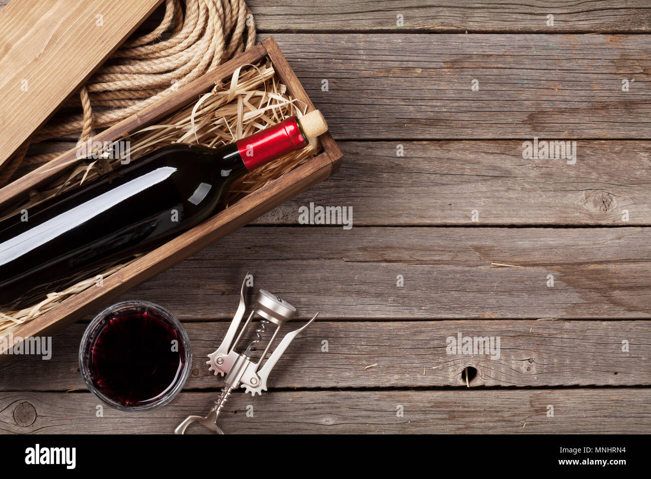 Red wine bottle and glass on wooden table. Top view with copy space ...