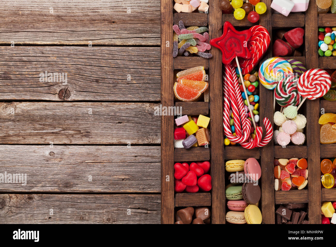 Colorful sweets box. Lollipops, macaroons, marshmallow, marmalade and ...