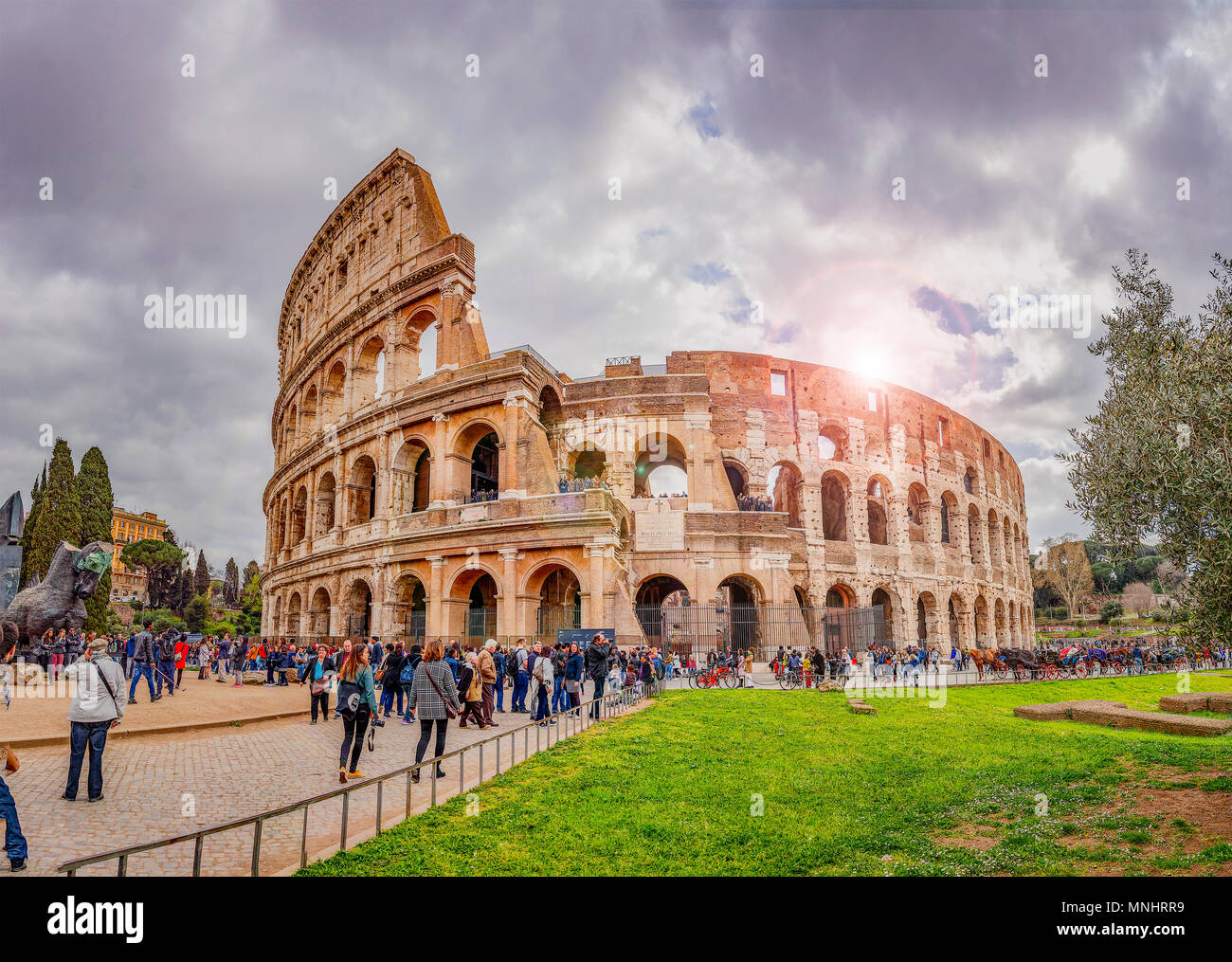 Rome, Italy, march 2017: tourists walking under the colosseum in rome ...