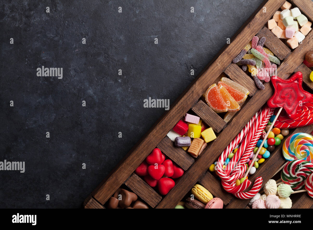 Colorful sweets box. Lollipops, macaroons, marshmallow, marmalade and ...