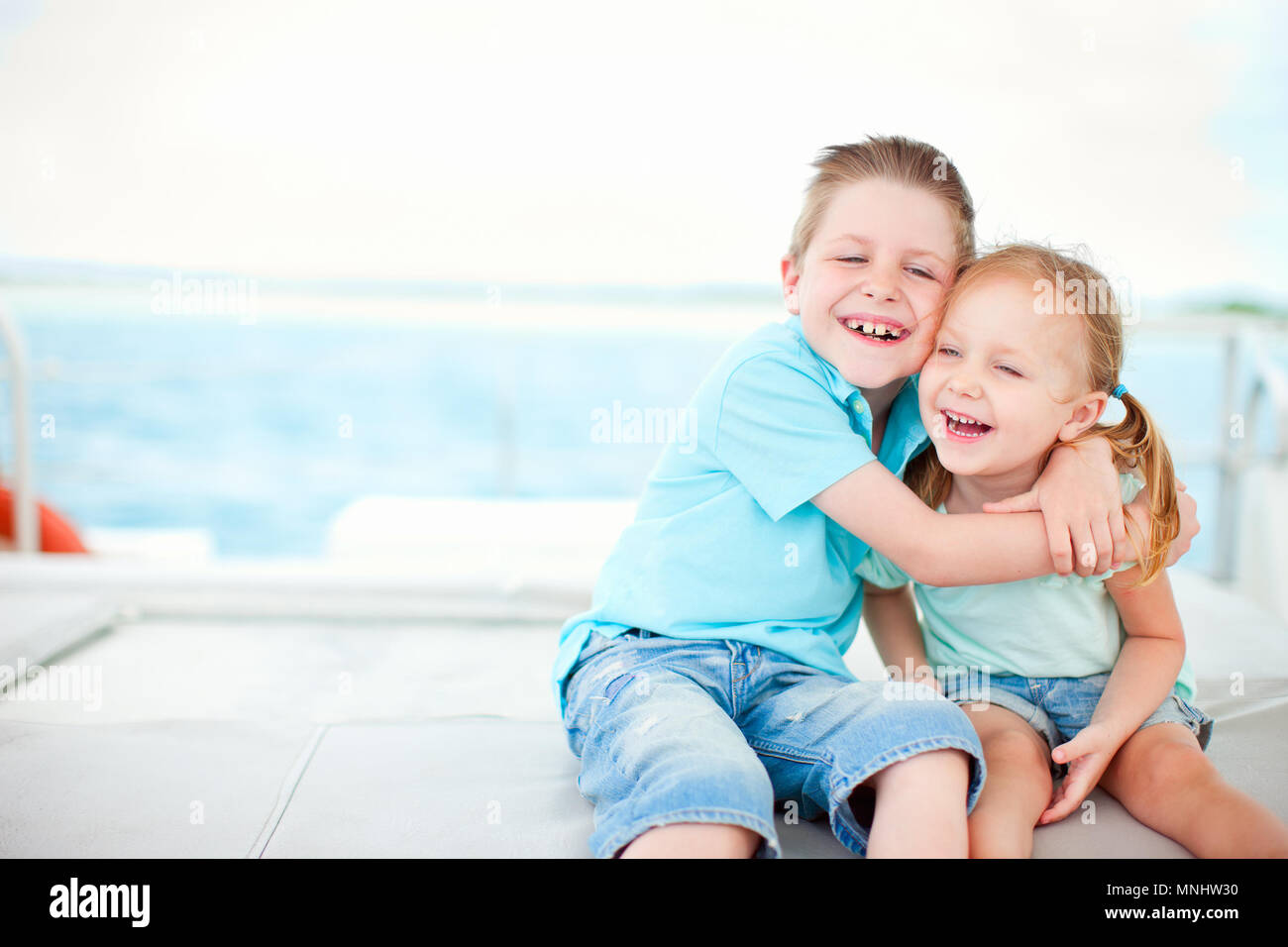Happy brother and sister embracing each other Stock Photo - Alamy