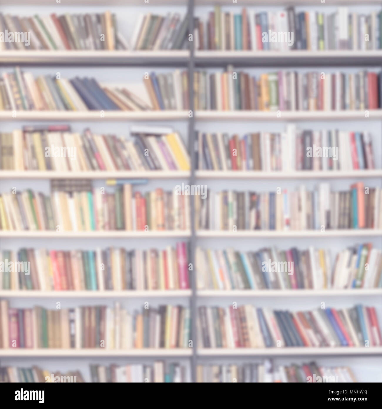 Abstract blurred bookshelves with books, manuals, textbooks in library ...