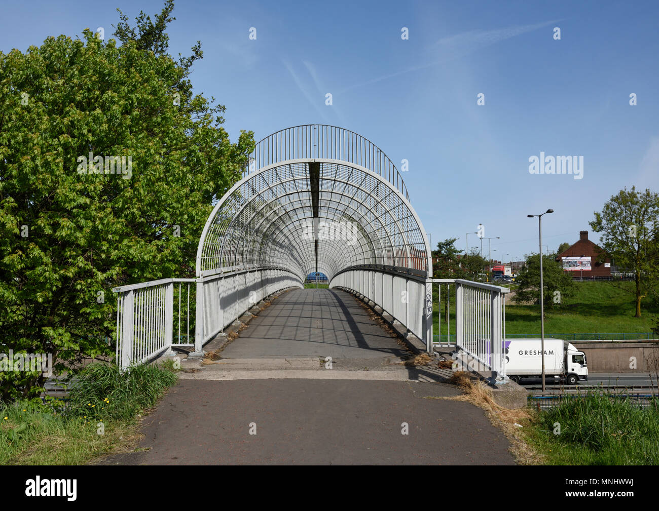 Enclosed pedestrian footbridge with steel safety cage, over m60 ...